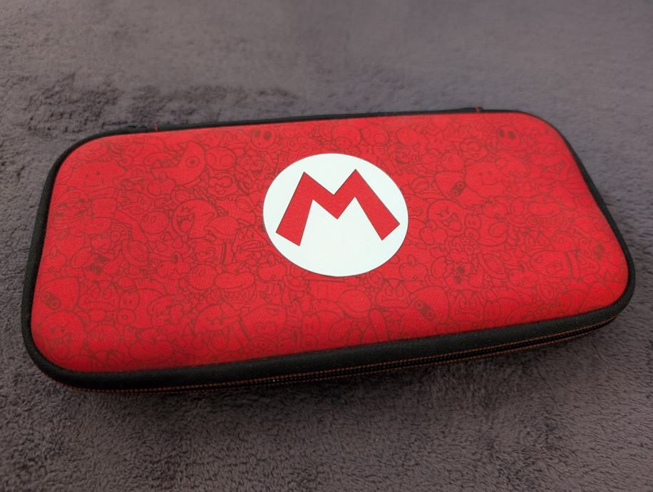 Nintendo Switch v2 (Mariko) konzola + torbica i 2 igre